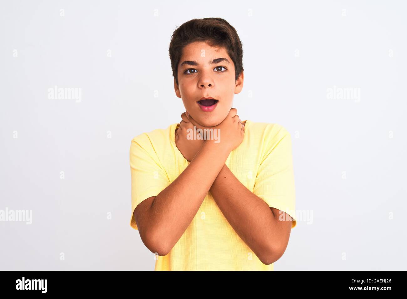 Handsome teenager boy standing over white isolated background shouting ...
