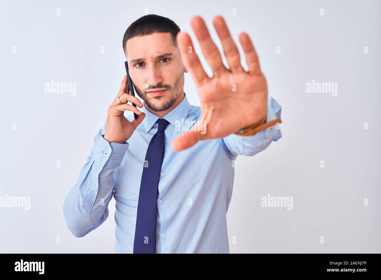 Young handsome business man calling using smartphone over isolated ...