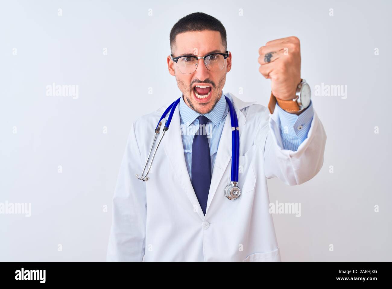 Young doctor man wearing stethoscope over isolated background angry and ...