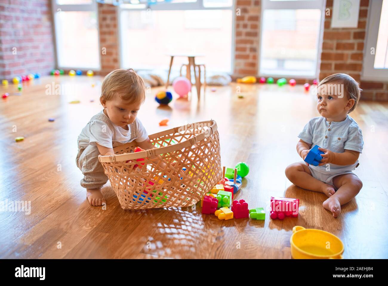 Beautiful toddlers playing around lots of toys at kindergarten Stock ...