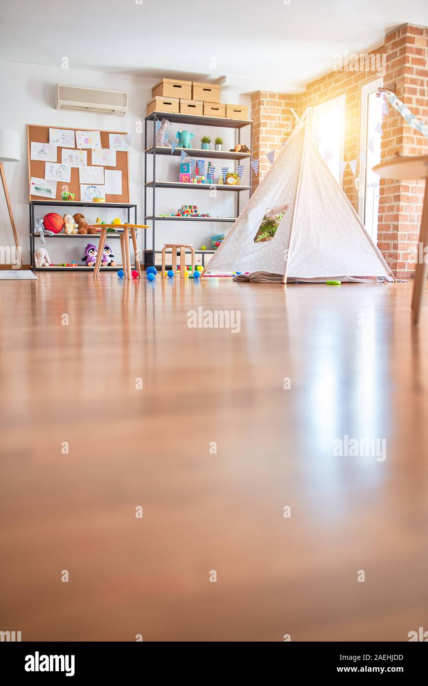 Picture of preschool playroom with colorful furniture, and toys around ...