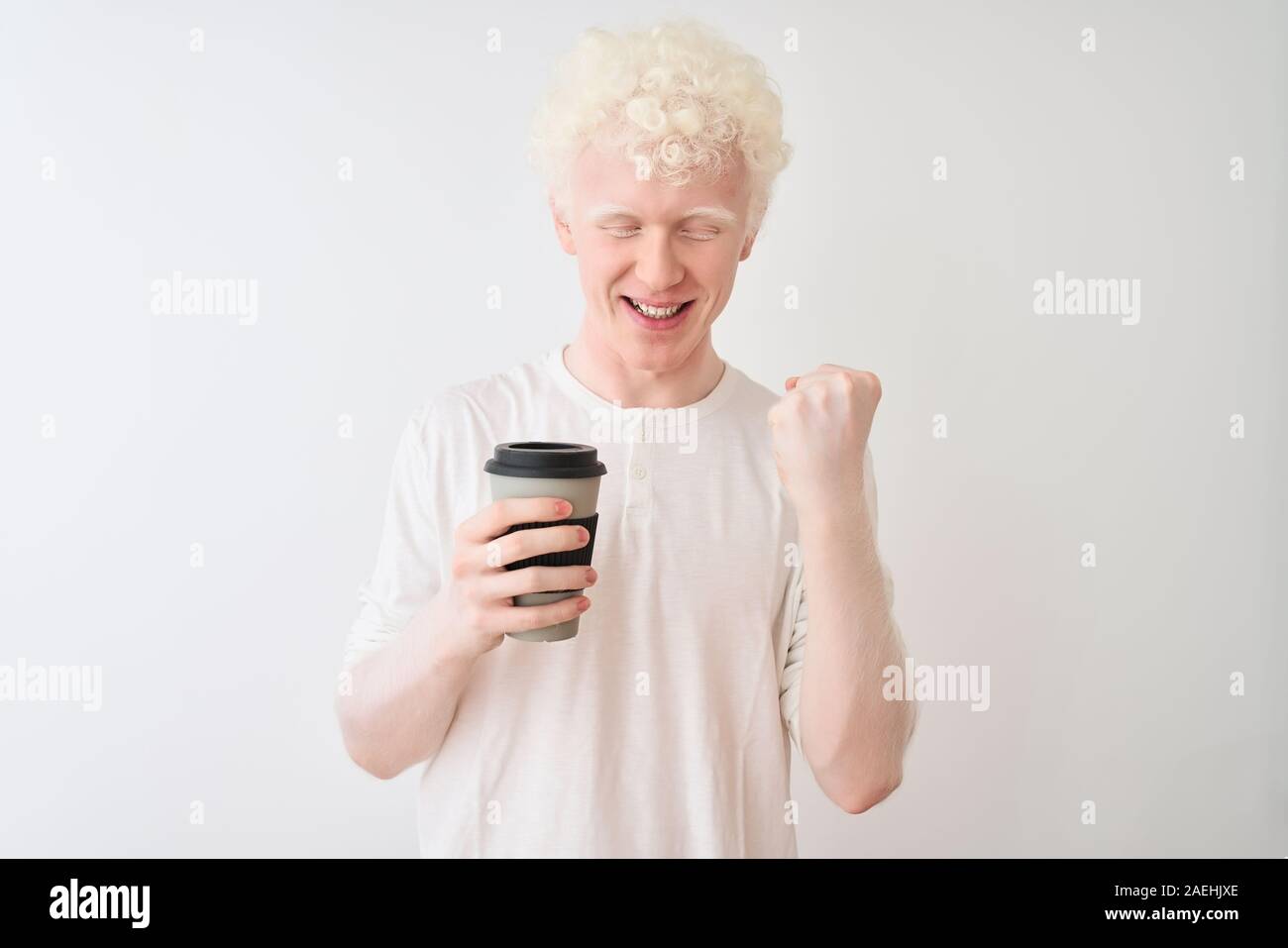 Young albino blond man drinking coffee standing over isolated white ...