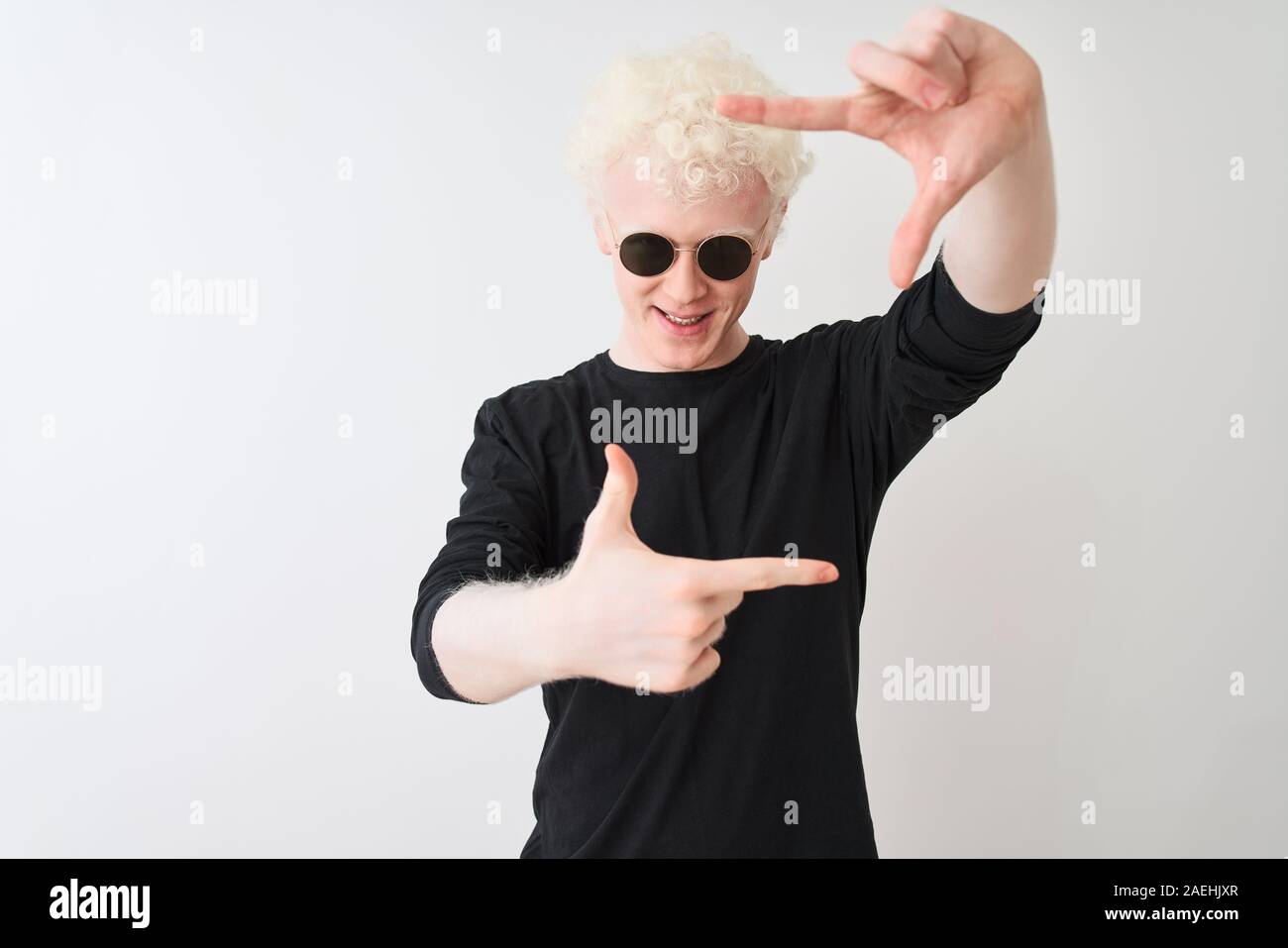 Young albino man wearing black t-shirt and sunglasess standing over ...