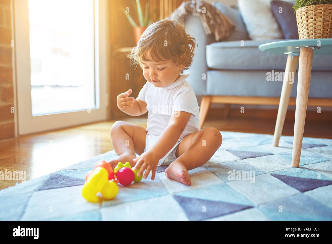 Beautiful toddler child girl playing with toys on the carpet Stock ...