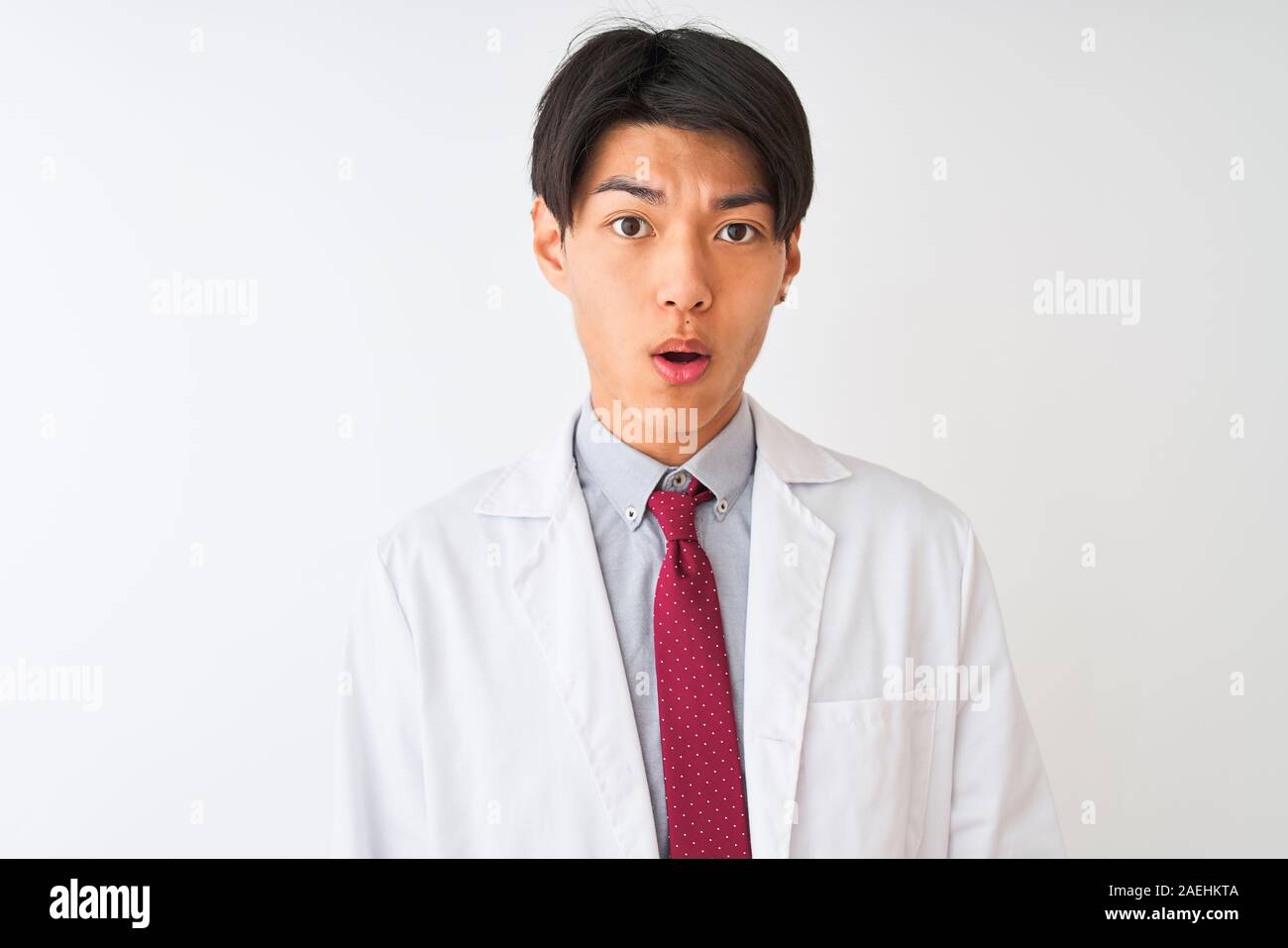 Chinese scientist man wearing tie and coat standing over isolated white ...