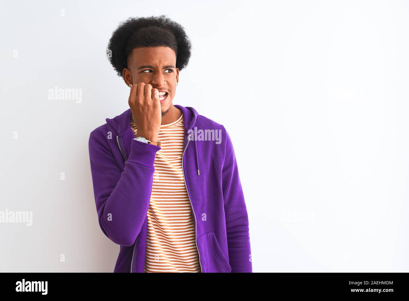 African american man wearing purple sweatshirt standing over isolated ...