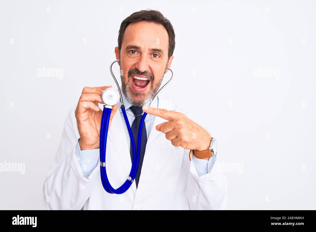 Middle age doctor man using stethoscope standing over isolated white ...