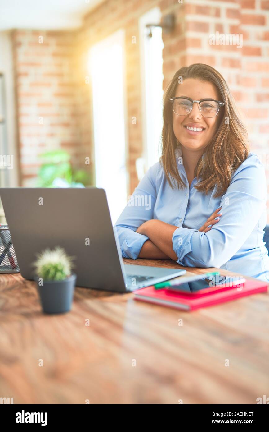 Young business woman sitting at desk working using computer laptop ...
