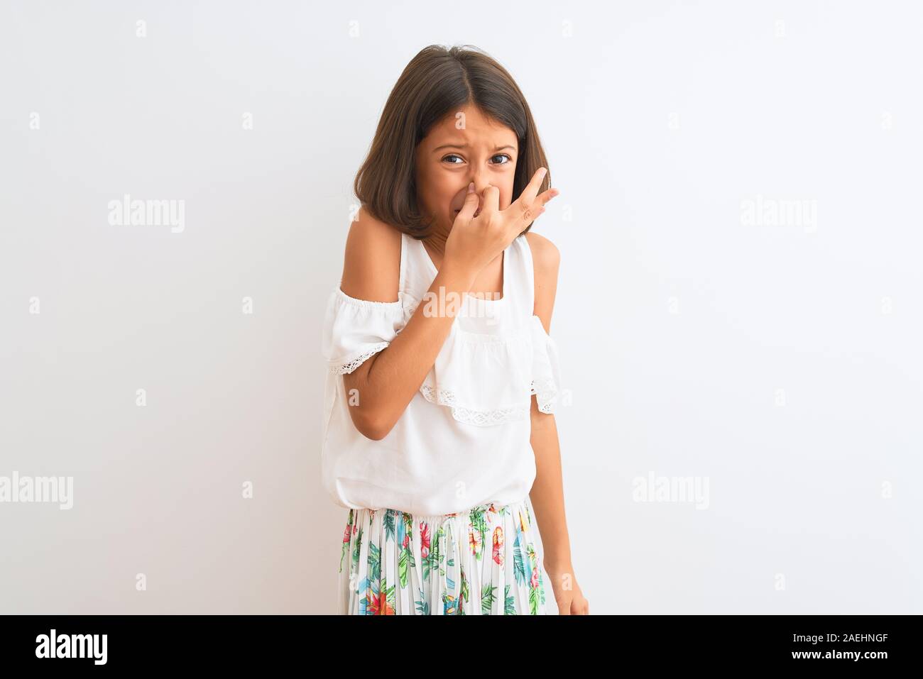 Young beautiful child girl wearing casual dress standing over isolated ...