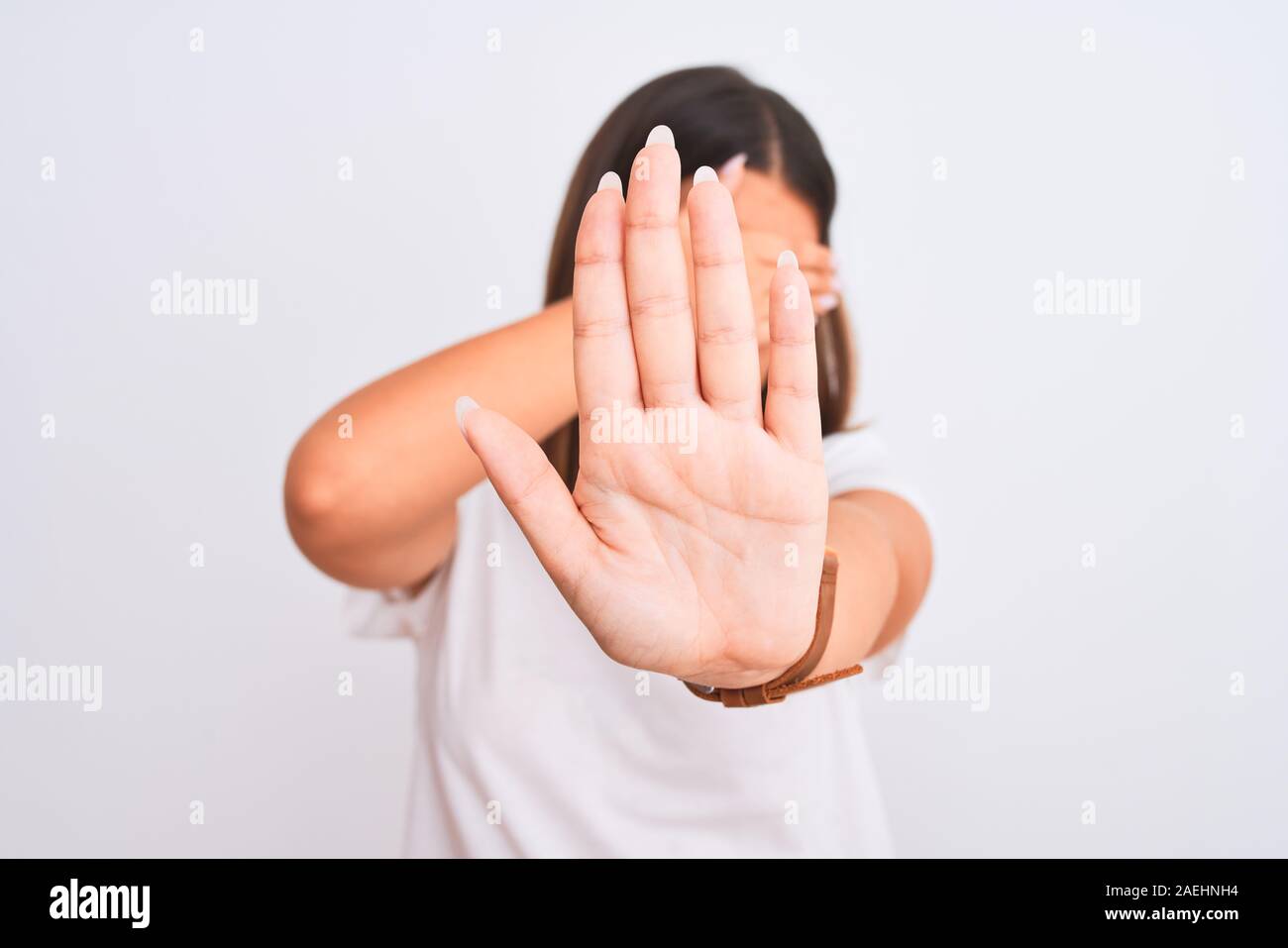 Portrait of beautiful and young brunette woman standing over isolated ...