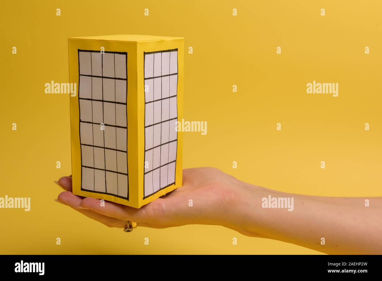 Yellow paper block of flats on yellow background paper. Minimalistic ...