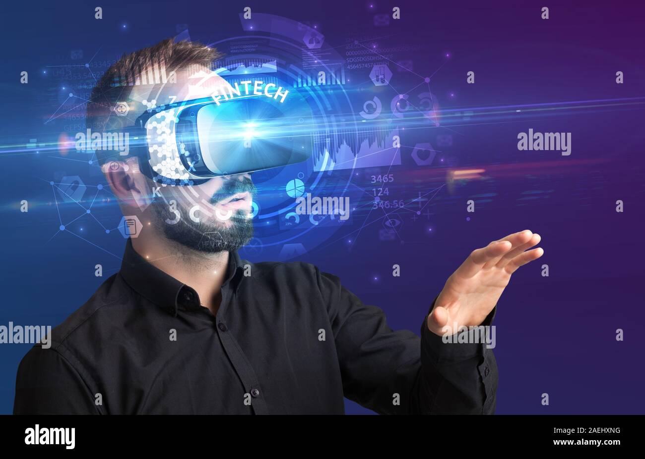 Businessman looking through Virtual Reality glasses with FINTECH ...