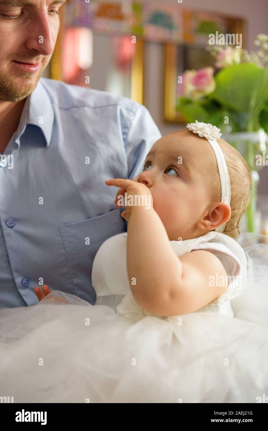 Baby girl 1 year old eating birthday cake in room. Birthday party ...