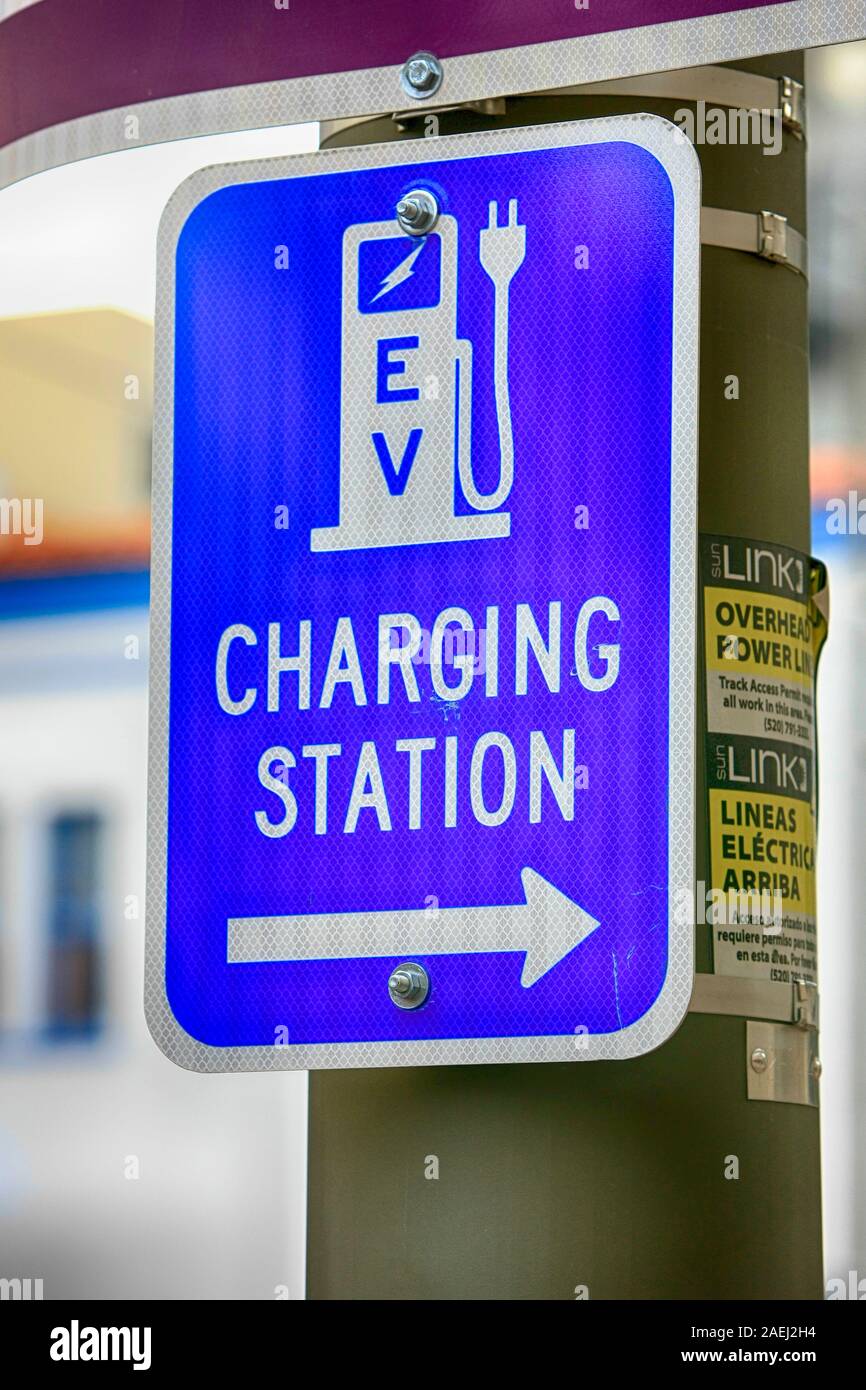 Blue and white information sign pointing to an EV (Electric Vehicle ...