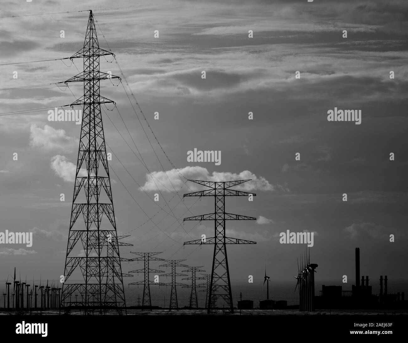 High voltage pylon wind turbines Black and White Stock Photos & Images ...