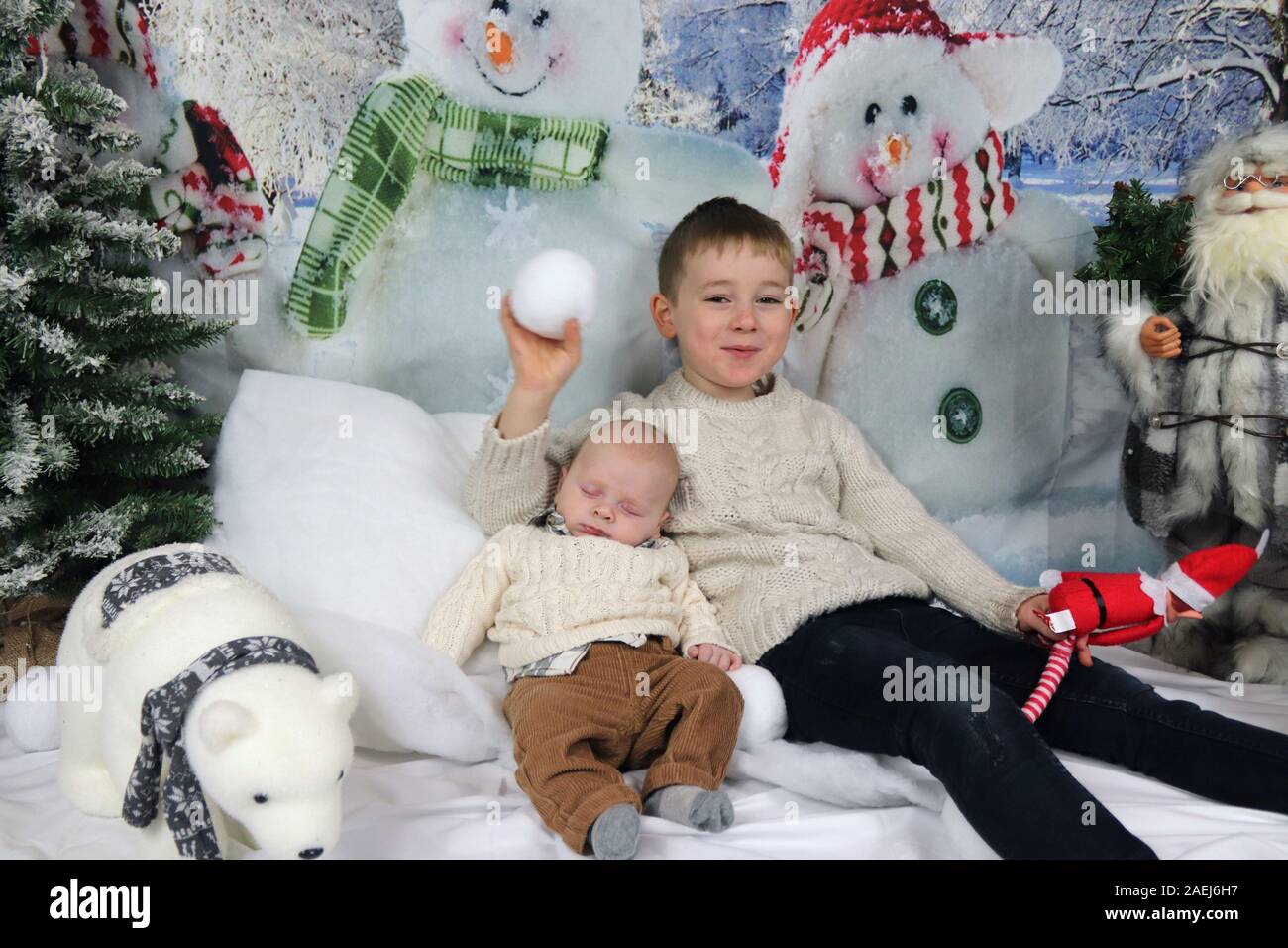 Two brother on the floor of a snow scene Stock Photo - Alamy
