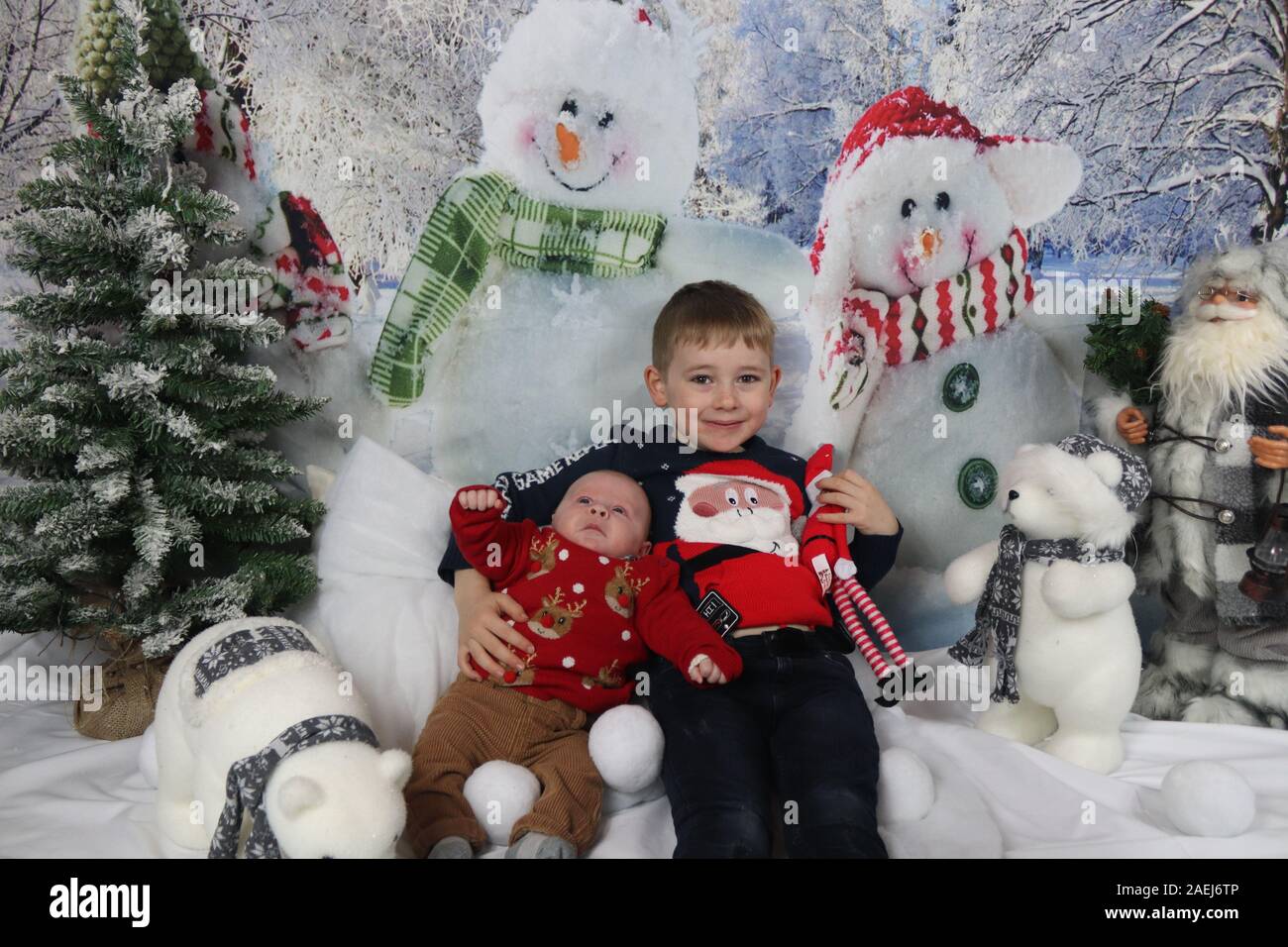 Two brother on the floor of a snow scene Stock Photo - Alamy