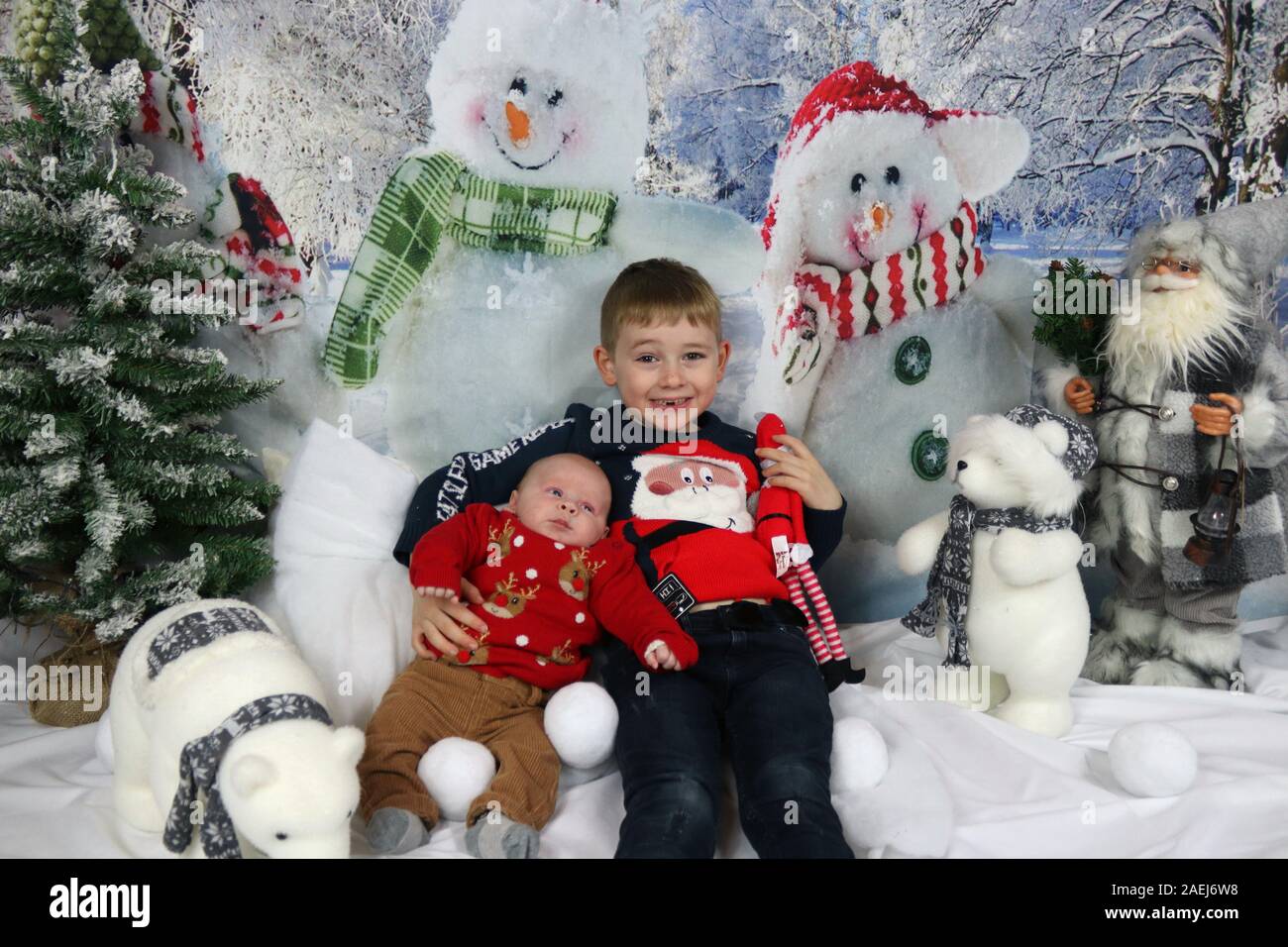 Two brother on the floor of a snow scene Stock Photo - Alamy
