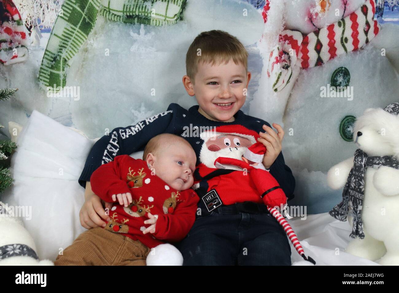 Two brother on the floor of a snow scene Stock Photo - Alamy