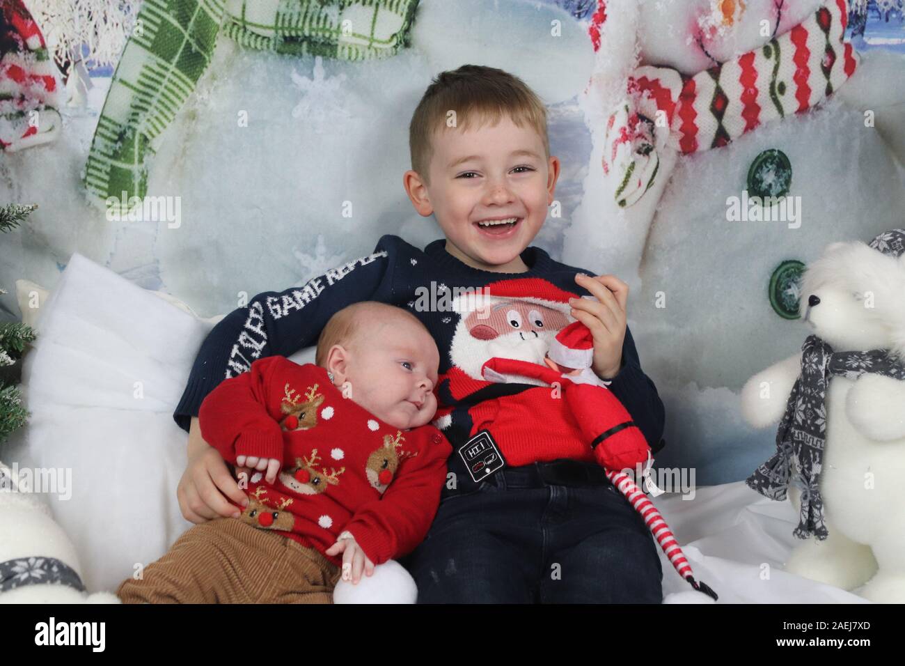 Two brother on the floor of a snow scene Stock Photo - Alamy