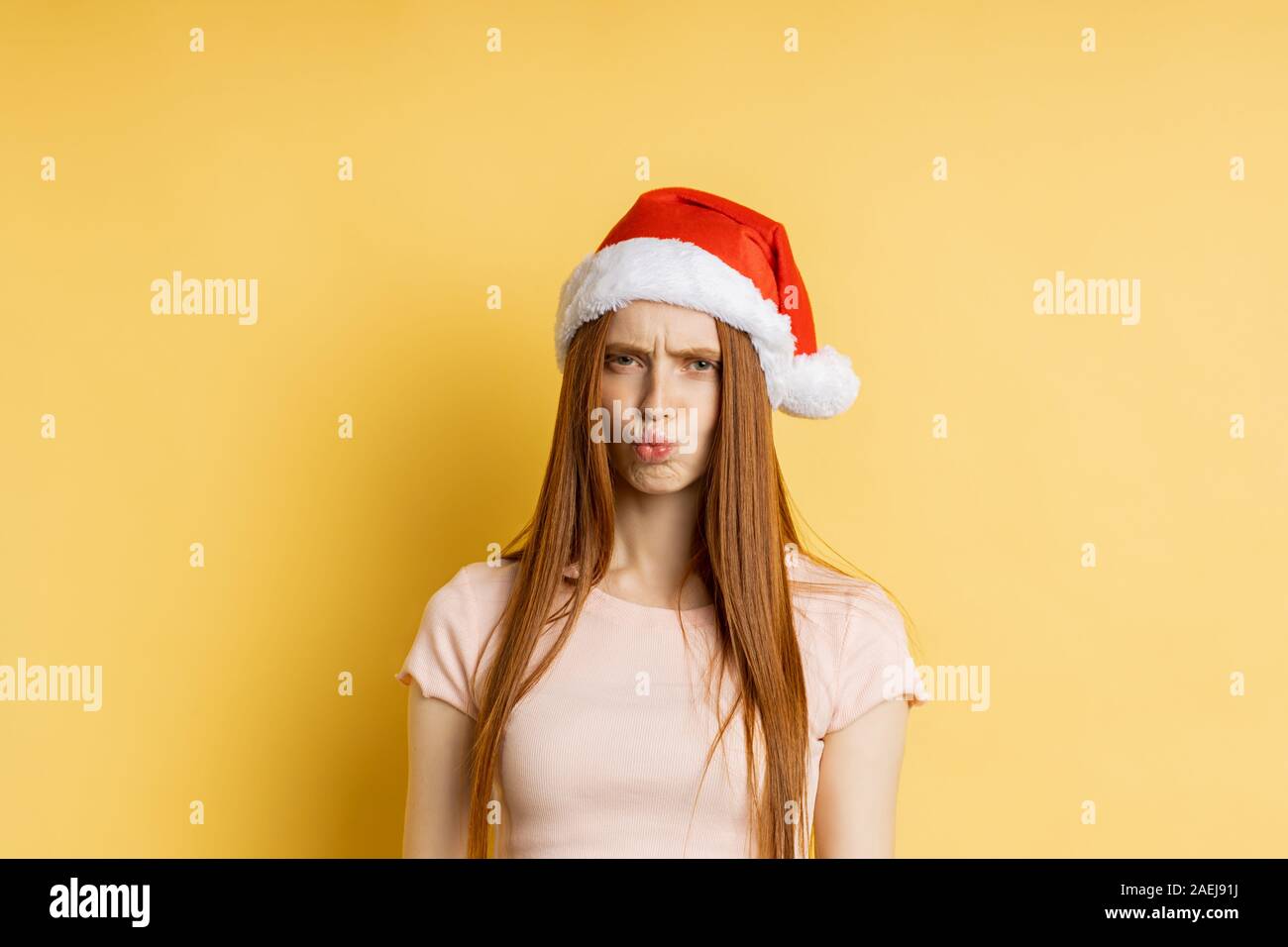 Shot of resentful displeased frowning ginger woman with long hair ...