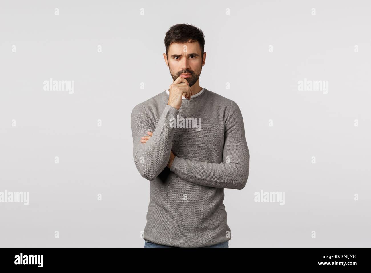 Concerned and serious young man trying understand how solve problem ...