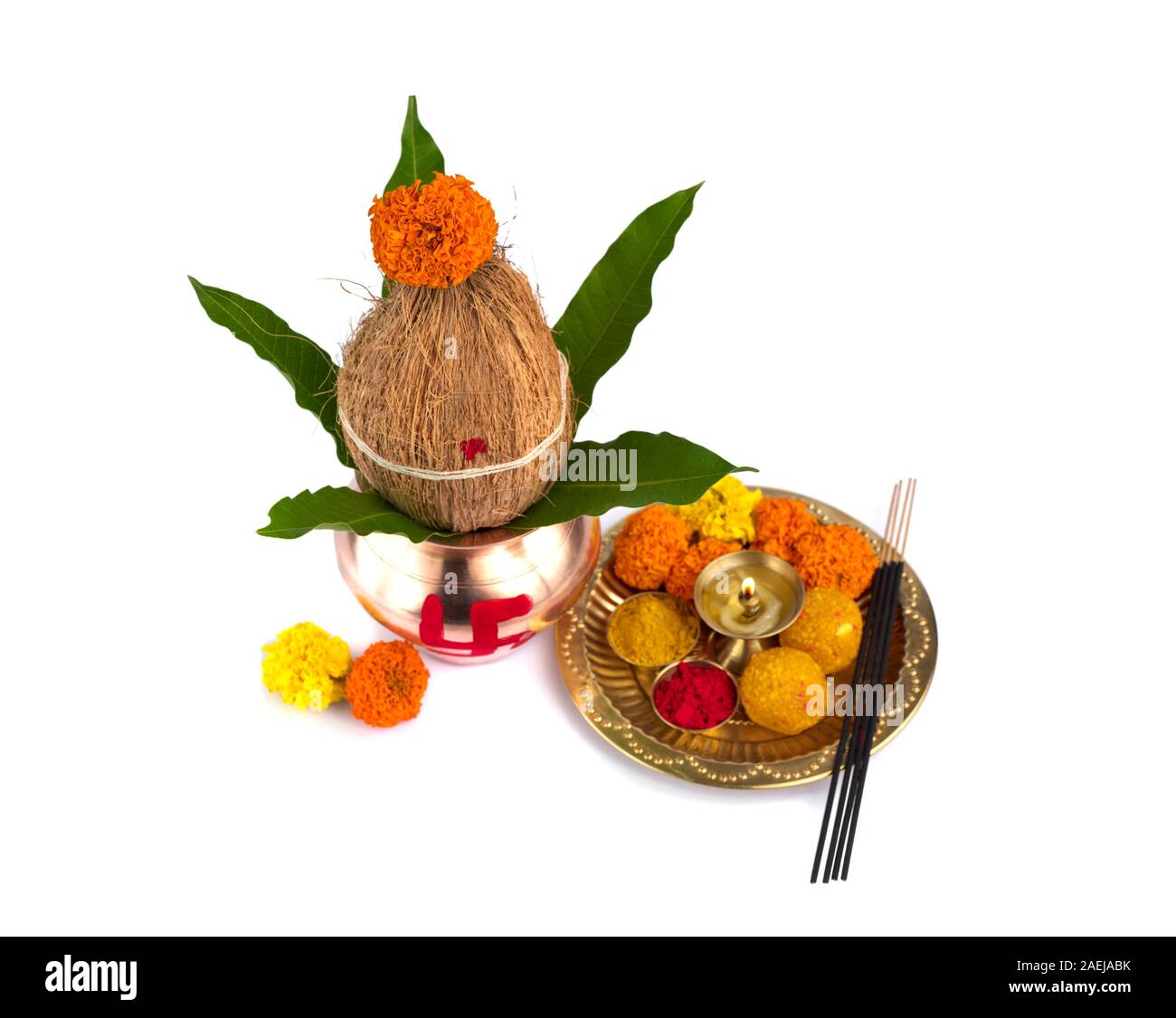 Copper Kalash with coconut and mango leaf and pooja thali with diya ...