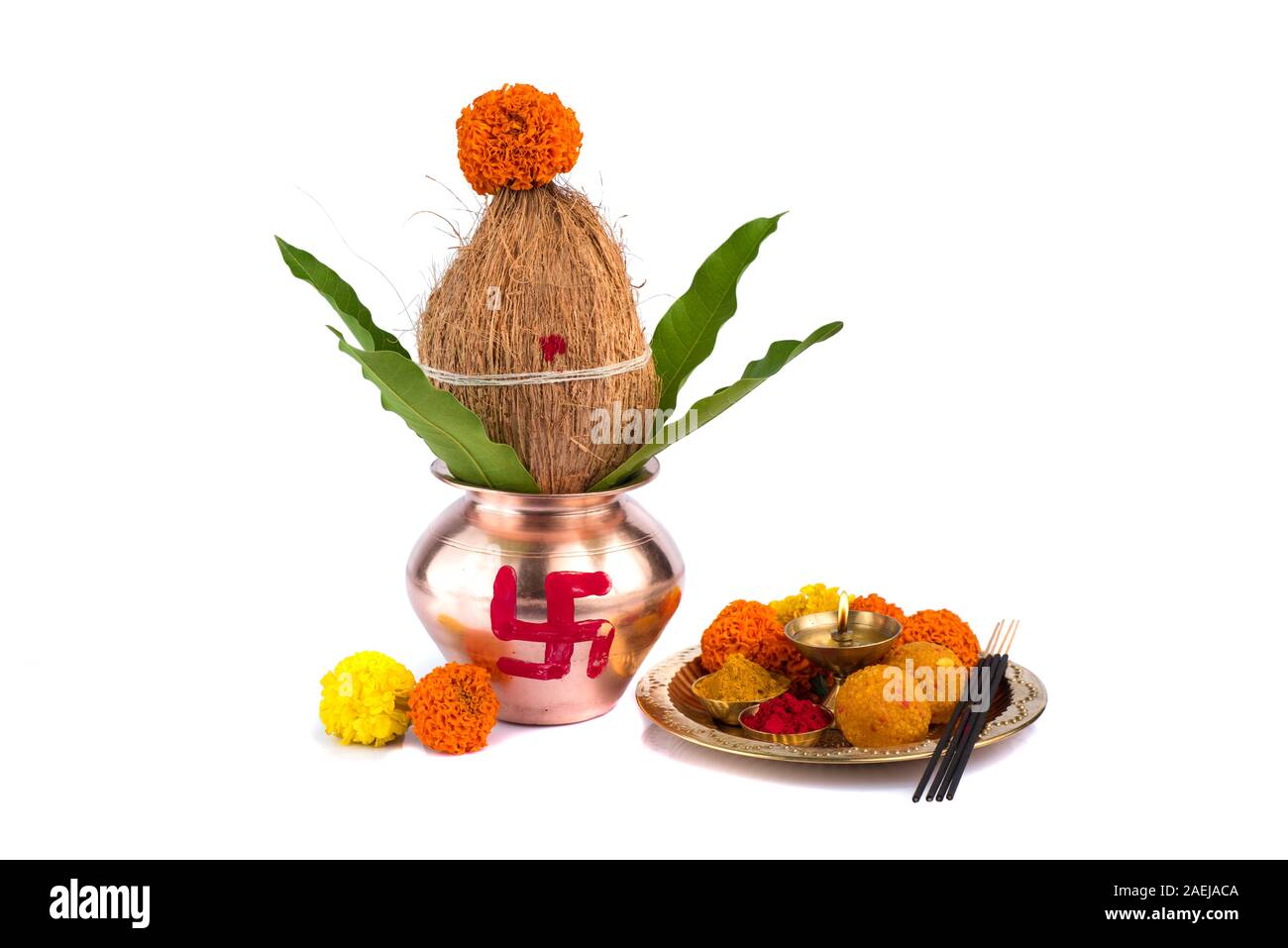 Copper Kalash with coconut and mango leaf and pooja thali with diya ...