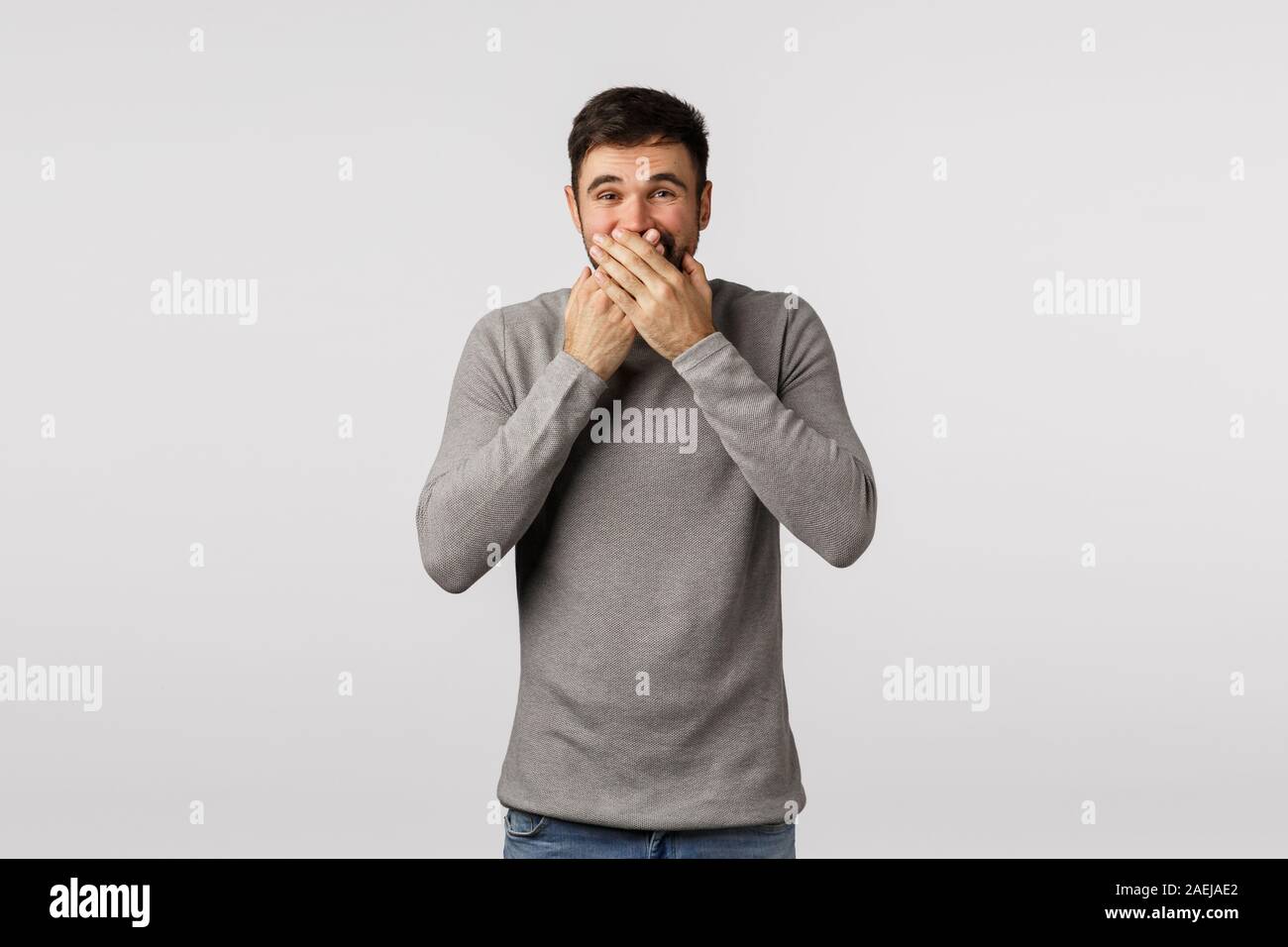 Man cant hold laugh at serious meeting, hiding smile behind mouth ...