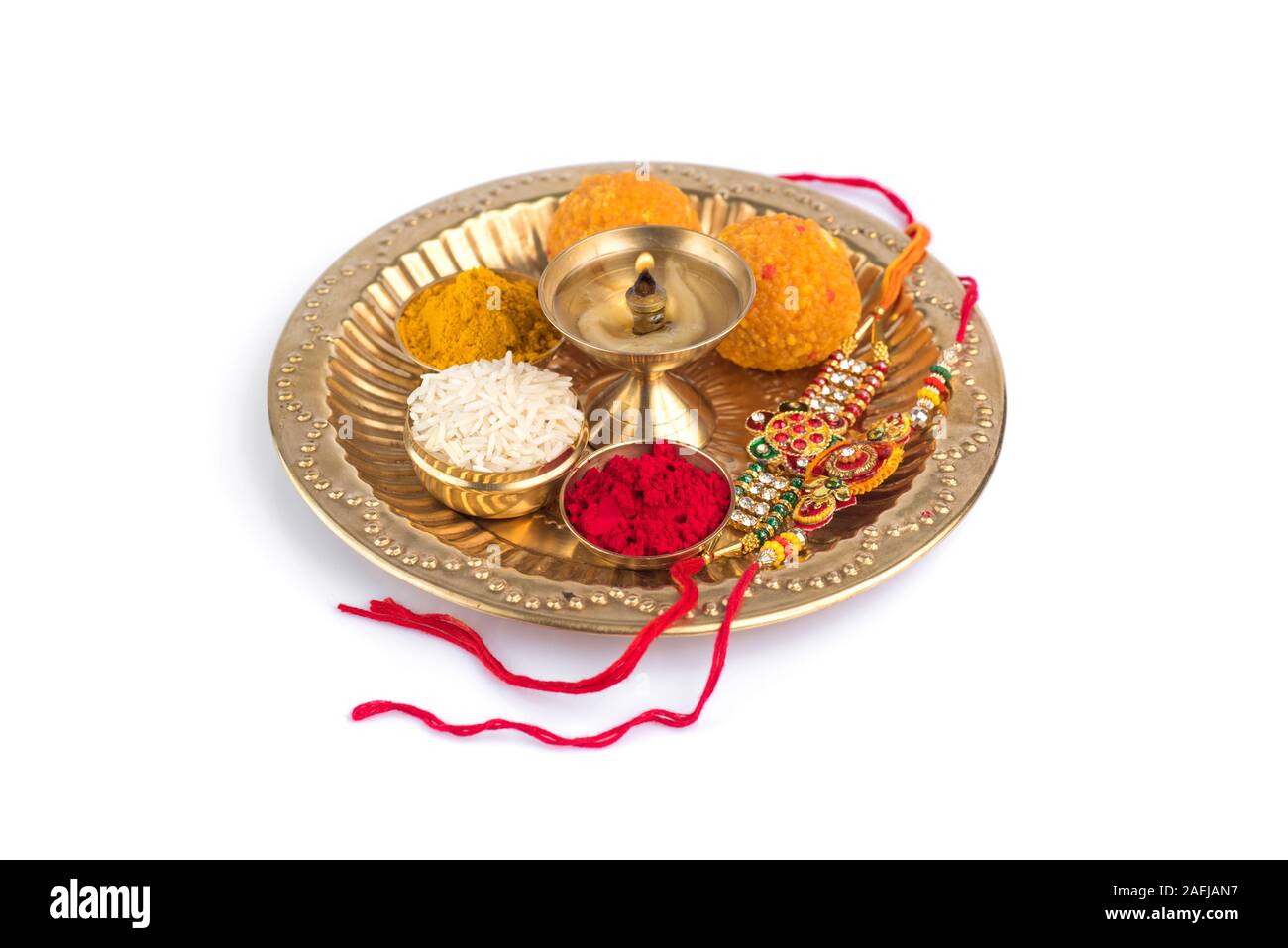 Indian Festival: Rakhi with rice grains, kumkum, sweets and diya on ...