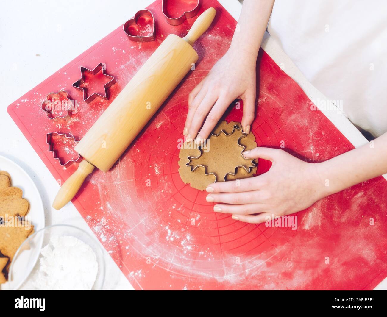 Christmas bakery. Woman making gingerbread, cutting cookies of ...