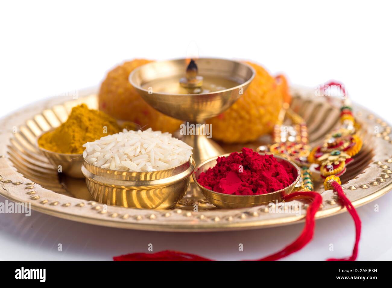 Indian Festival: Rakhi with rice grains, kumkum, sweets and diya on ...