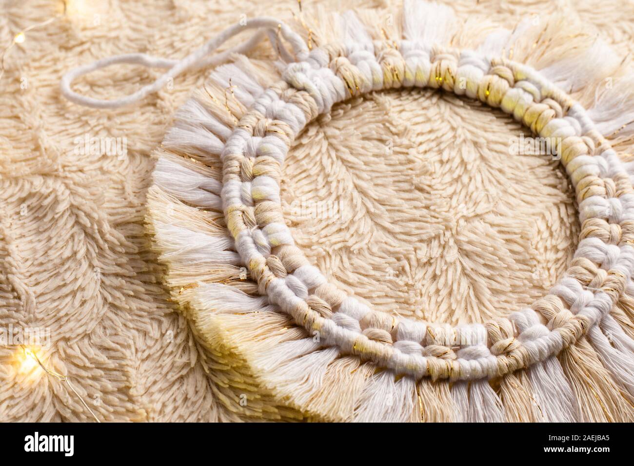 Handmade macrame circle decoration on artificial fur Stock Photo - Alamy