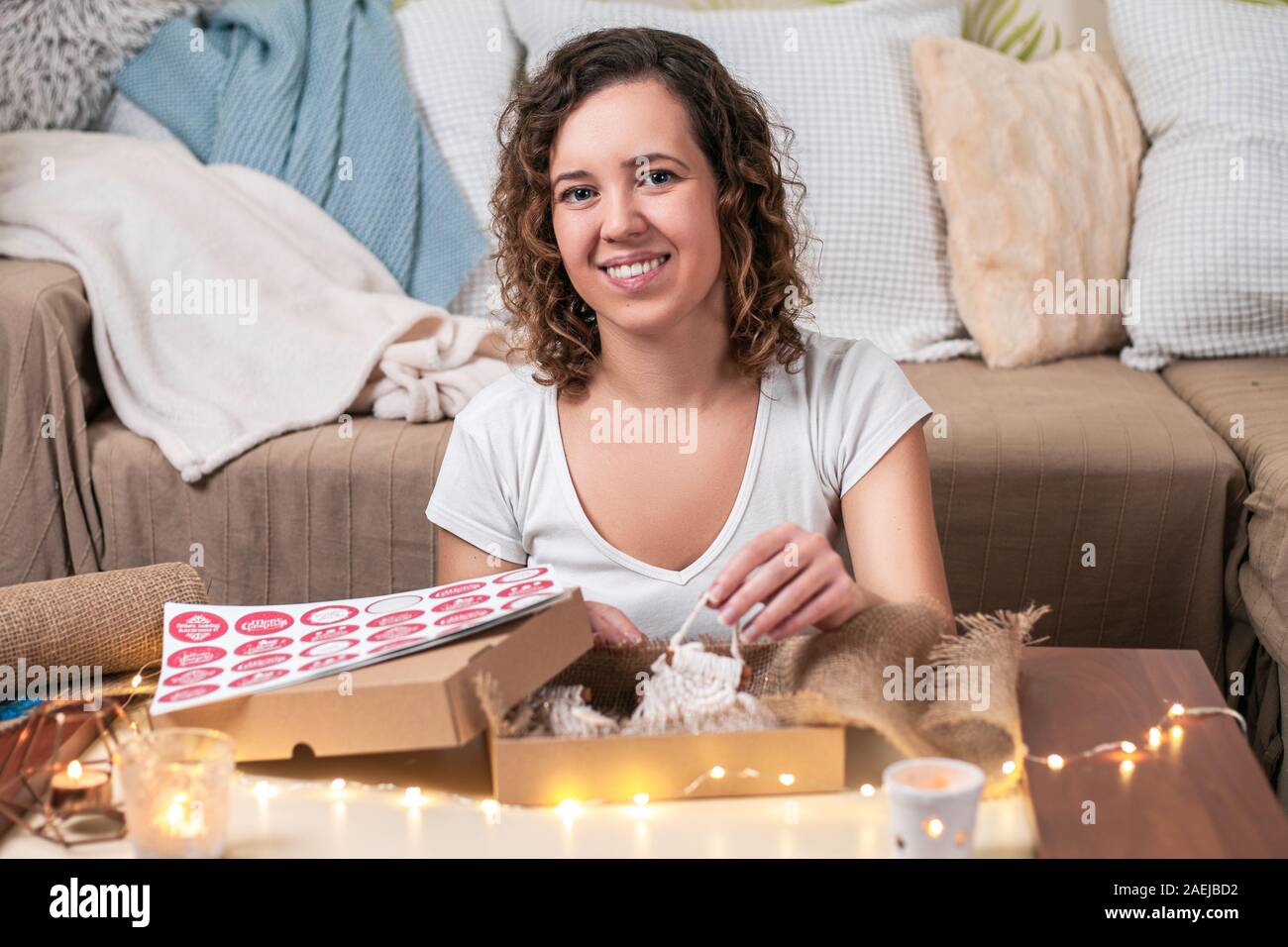 Woman packing surprise gift hi-res stock photography and images - Alamy