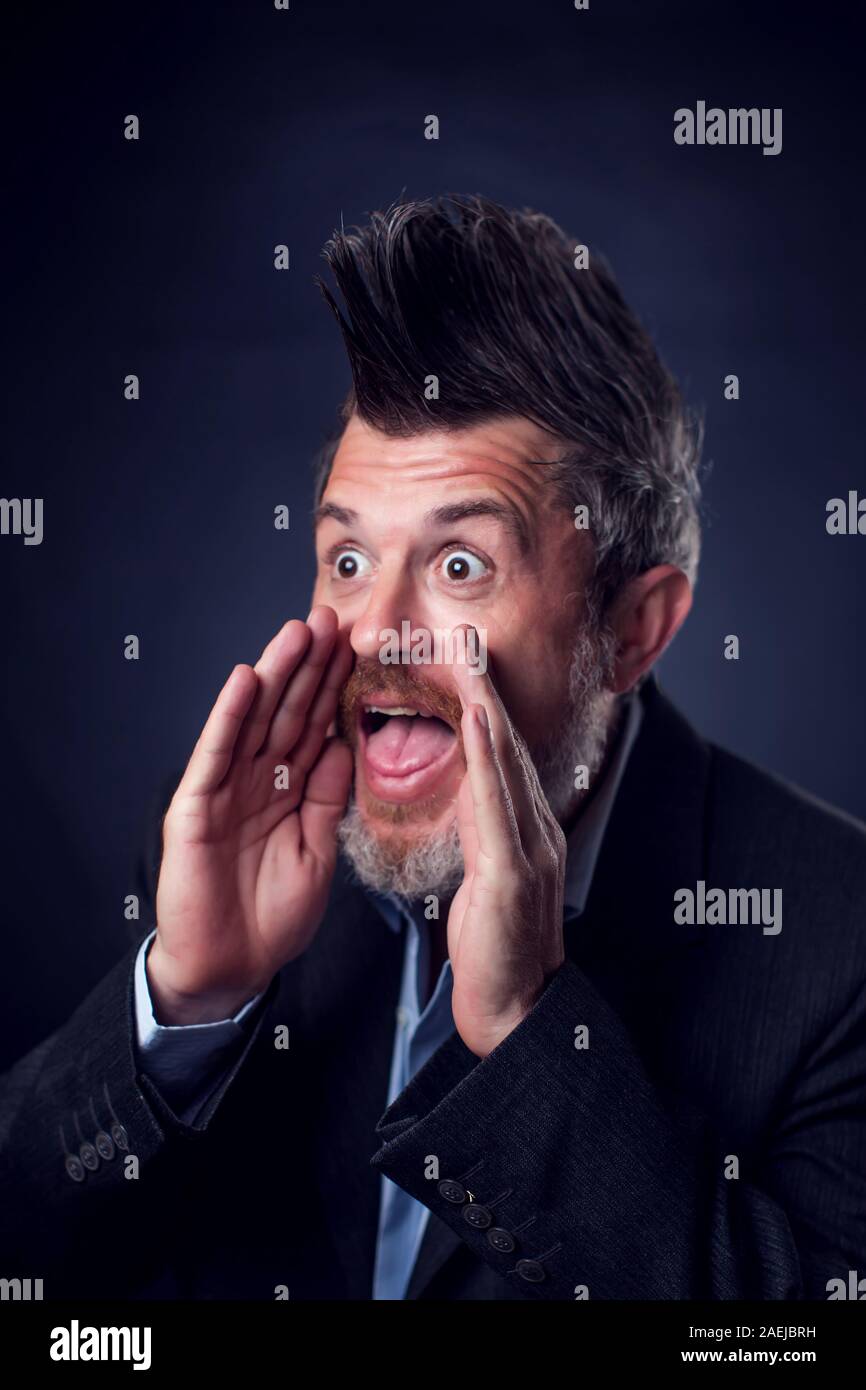 A portrait of screaming funny bearded man with iroquois wearing suit ...