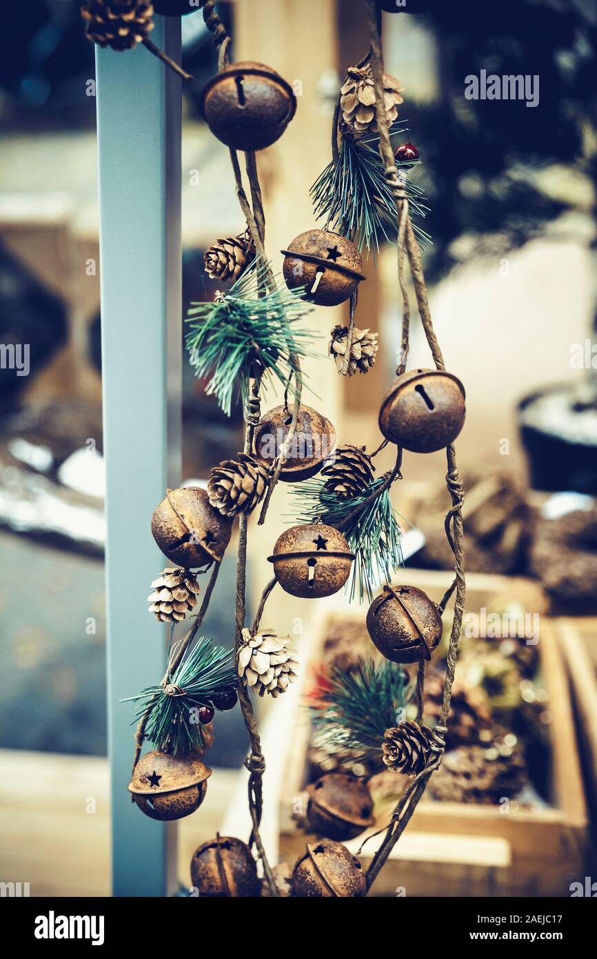 background of small brown bells and pine cones hanging from a pole ...