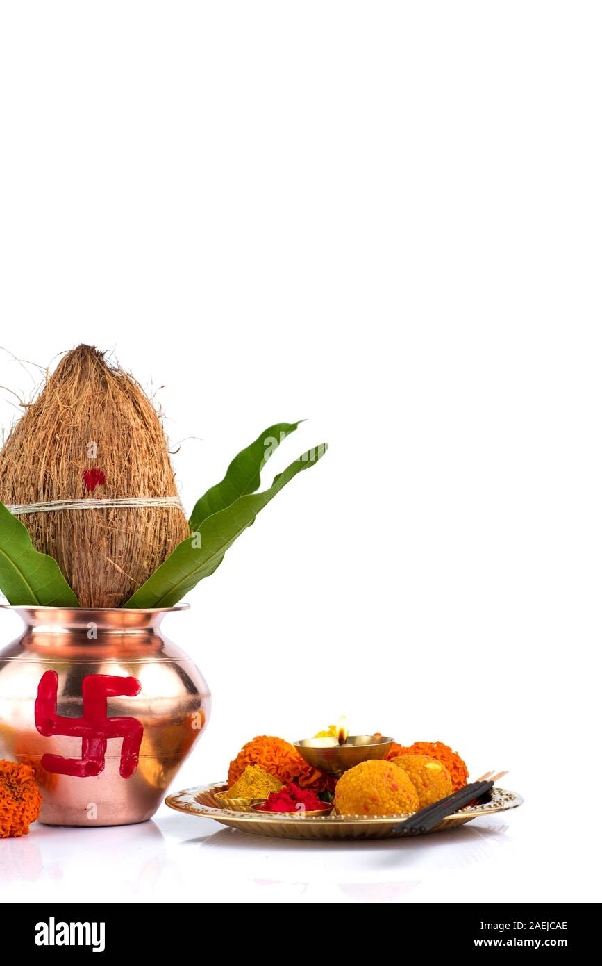 Copper Kalash with coconut and mango leaf and pooja thali with diya ...