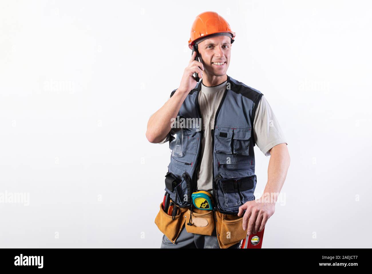 Builder talking on a cell phone Stock Photo - Alamy