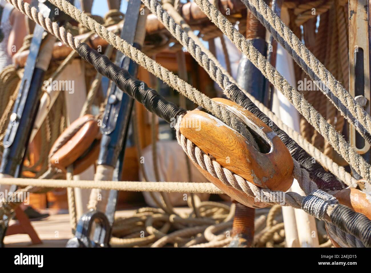 Close-up of a wooden rope pulley and ropes on an old sailing ship Stock ...