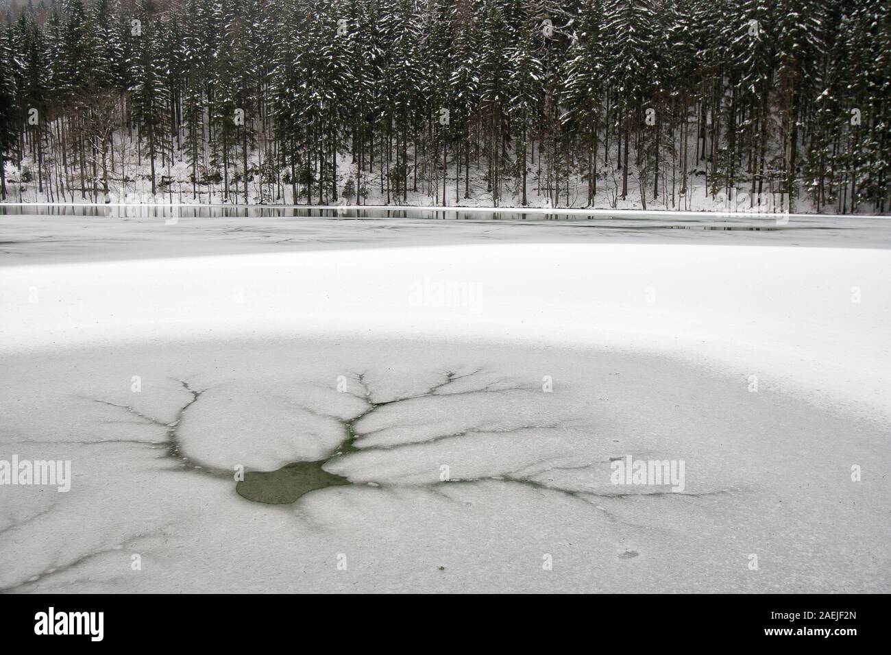 A partially frozen Lake Planšar (Planšarsko jezero) in Zgornje Jezersko ...