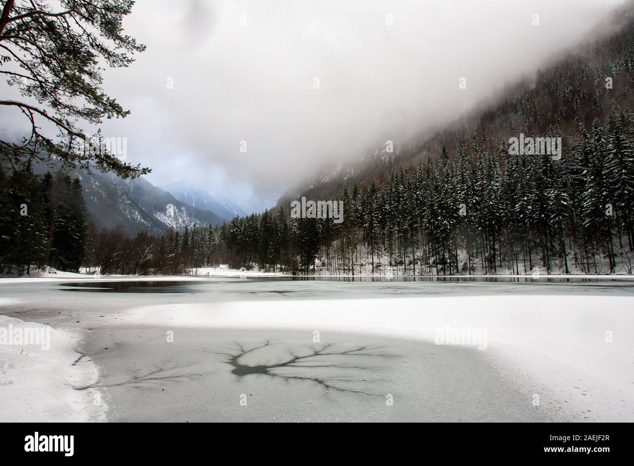 A partially frozen Lake Planšar (Planšarsko jezero) in Zgornje Jezersko ...