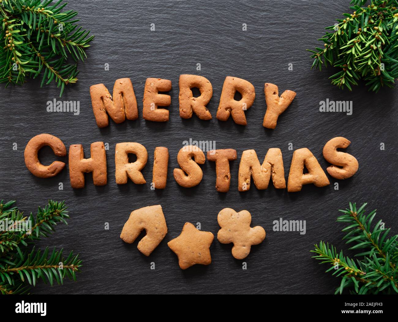 Gingerbread words Merry Christmas on dark stone background Stock Photo ...