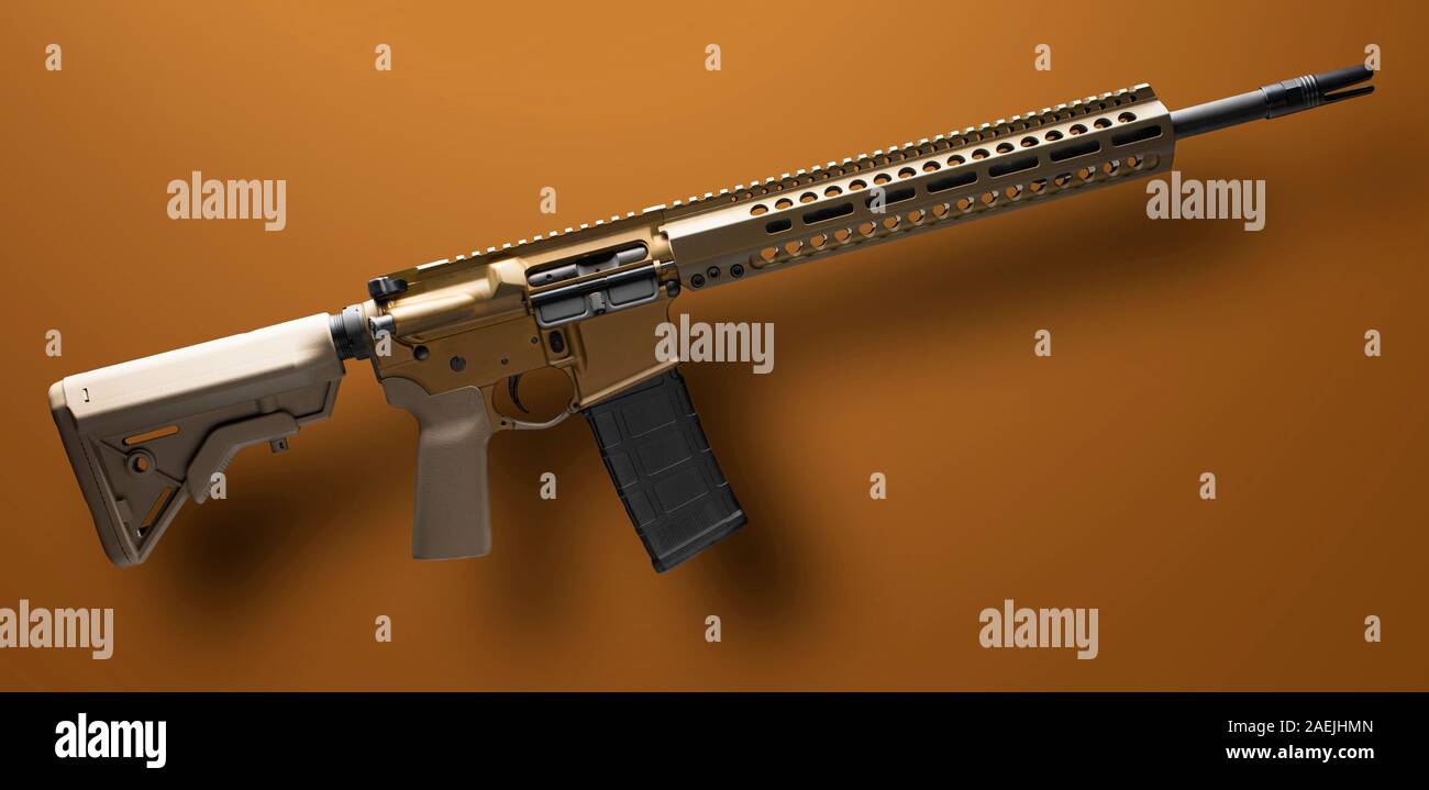 Brown assault rifle and pistol grip casting a shadow on a brown ...