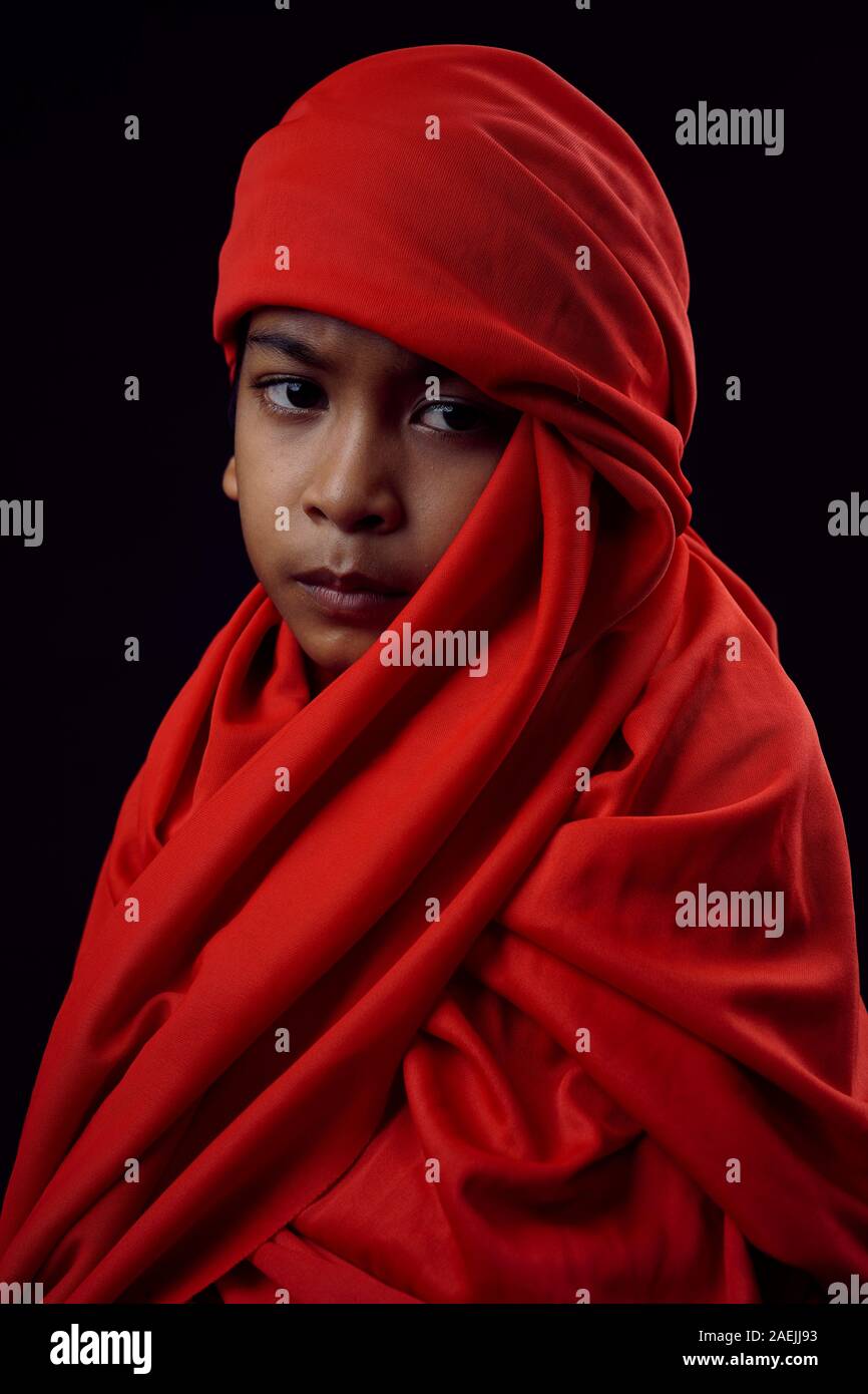 Portrait of Muslim young boy wearing red costume Stock Photo - Alamy