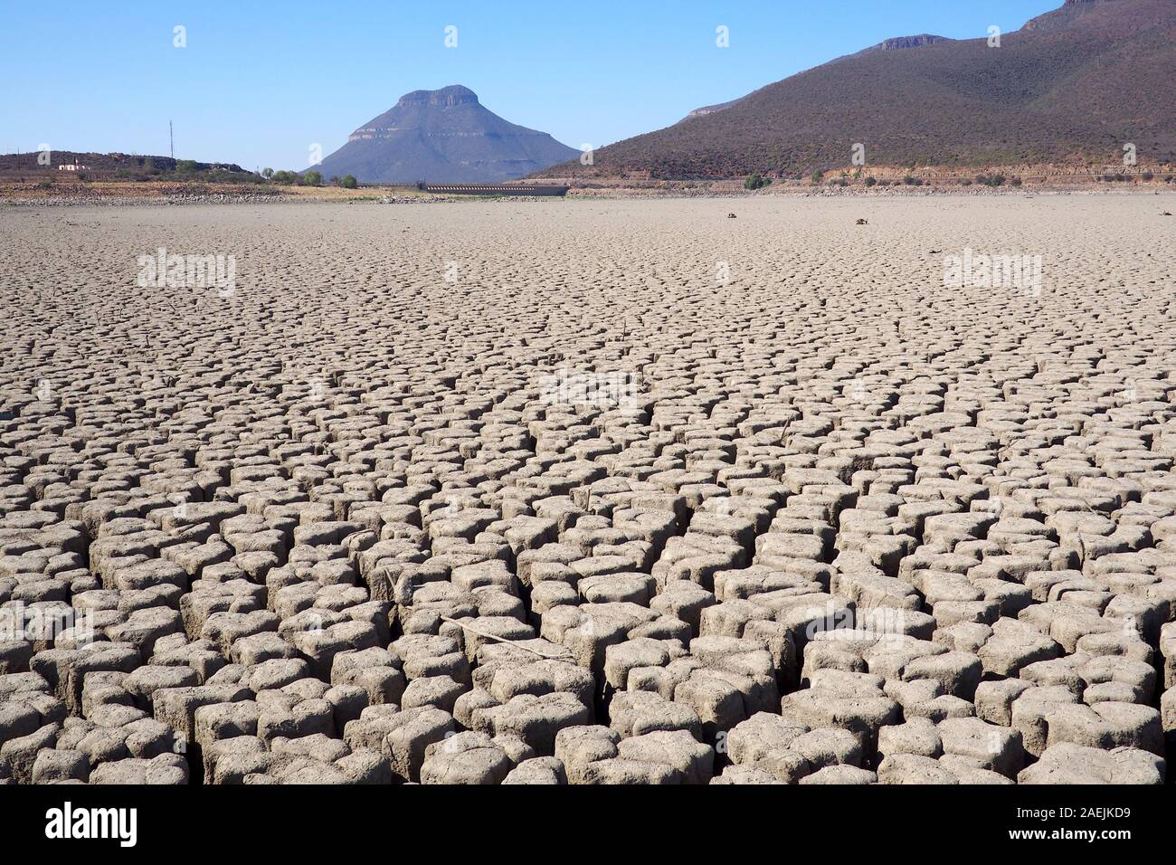 View over parched and empty dam, with cracked mud Stock Photo - Alamy