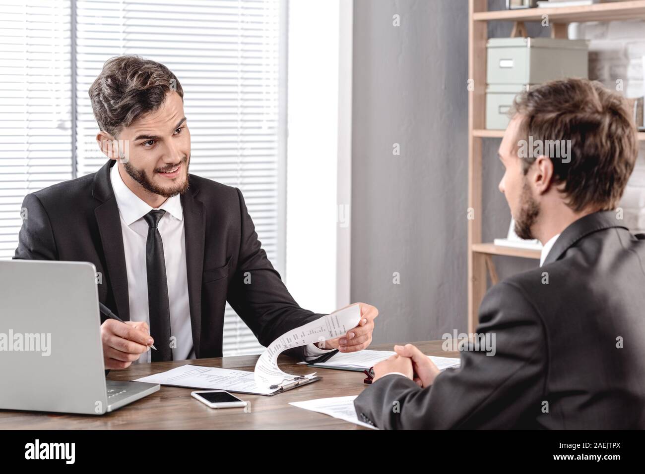 Job Interview. Employer checking application of candidate smiling ...