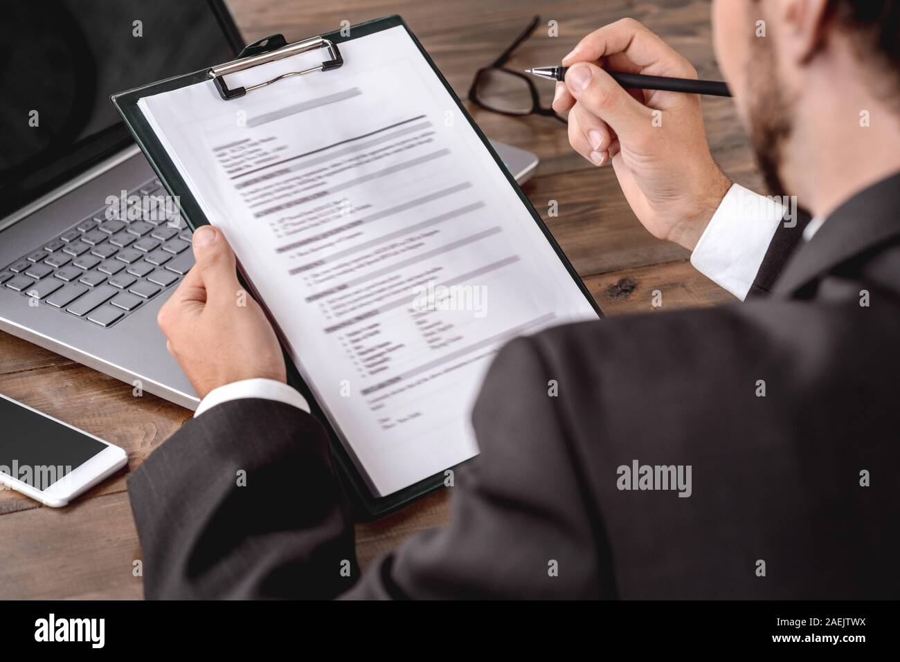 Employer filling candidate form sitting in office back view cllose-up ...
