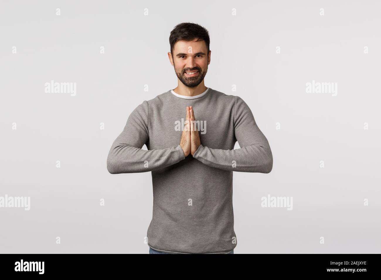Cheerful and peaceful adult male yoga instructor teaching how release ...