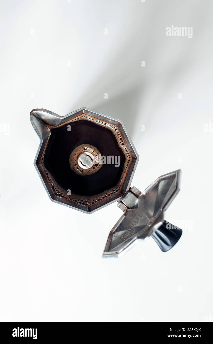 A moka pot (stove top coffee maker) full of coffee, shot overhead ...