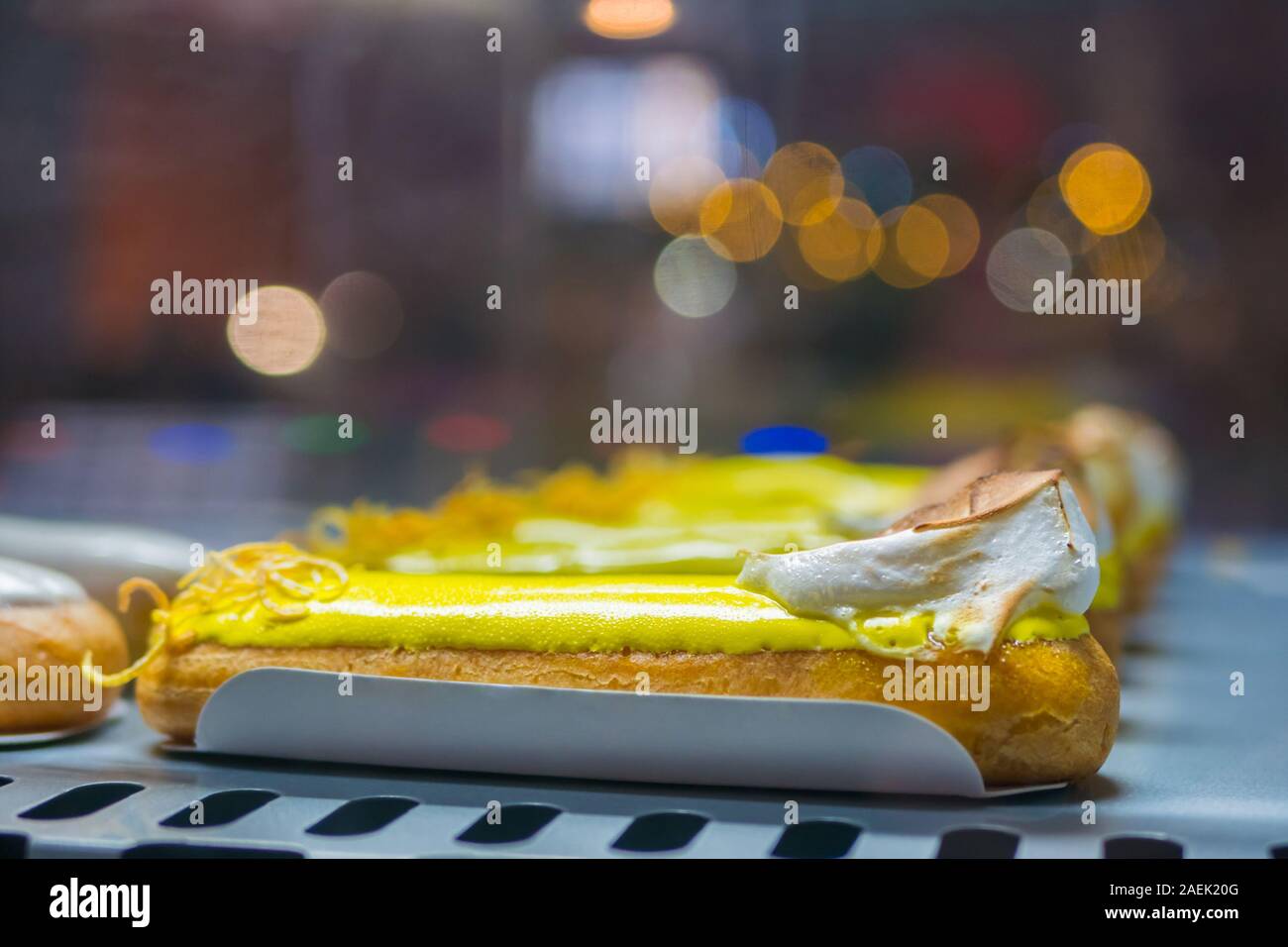Delicious fresh cake eclairs with cream for sale on counter Stock Photo ...
